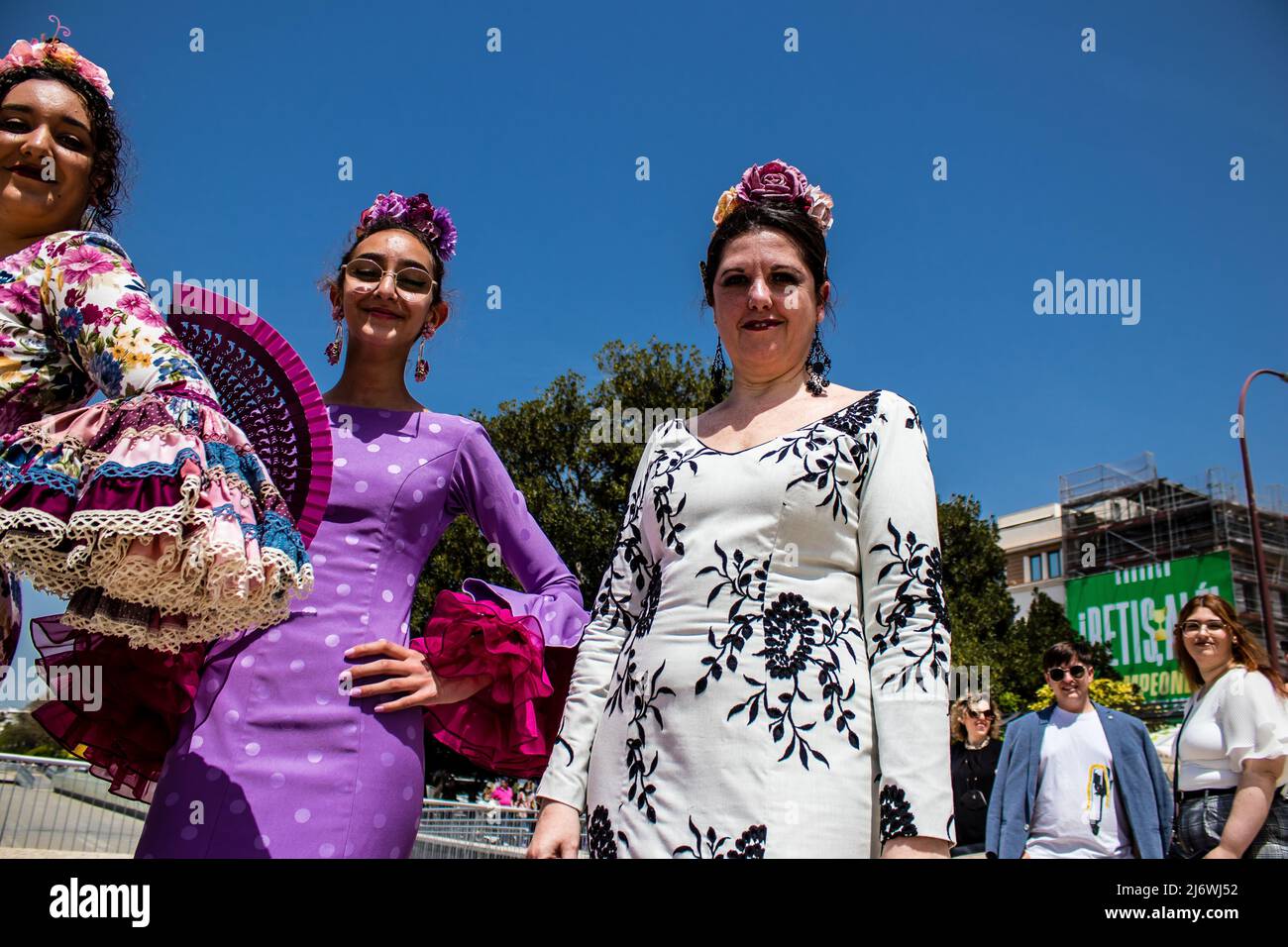 Seville, Spain - May 01, 2022 Sevillians dressed in traditional ...