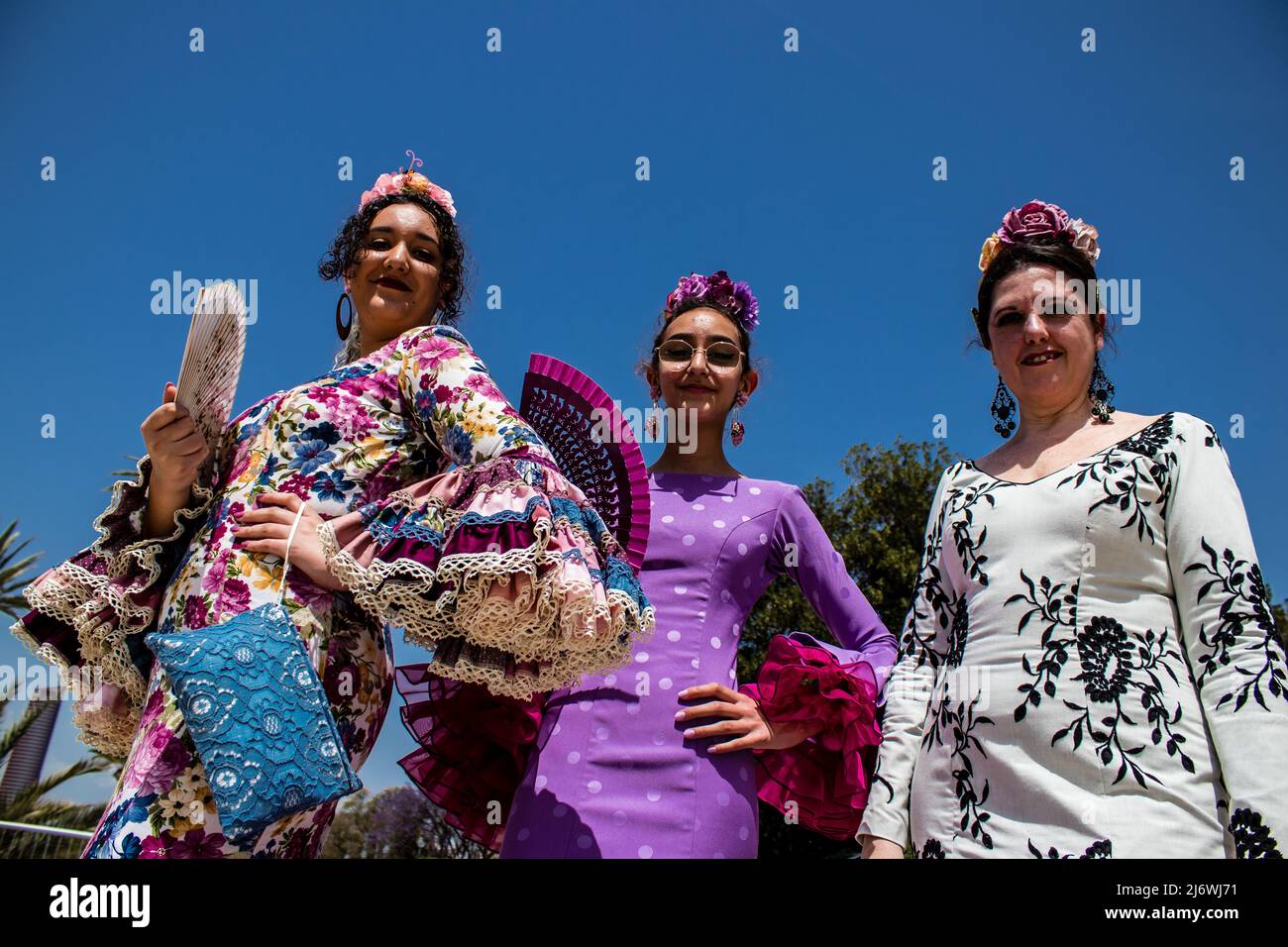 Seville, Spain - May 01, 2022 Sevillians dressed in traditional ...