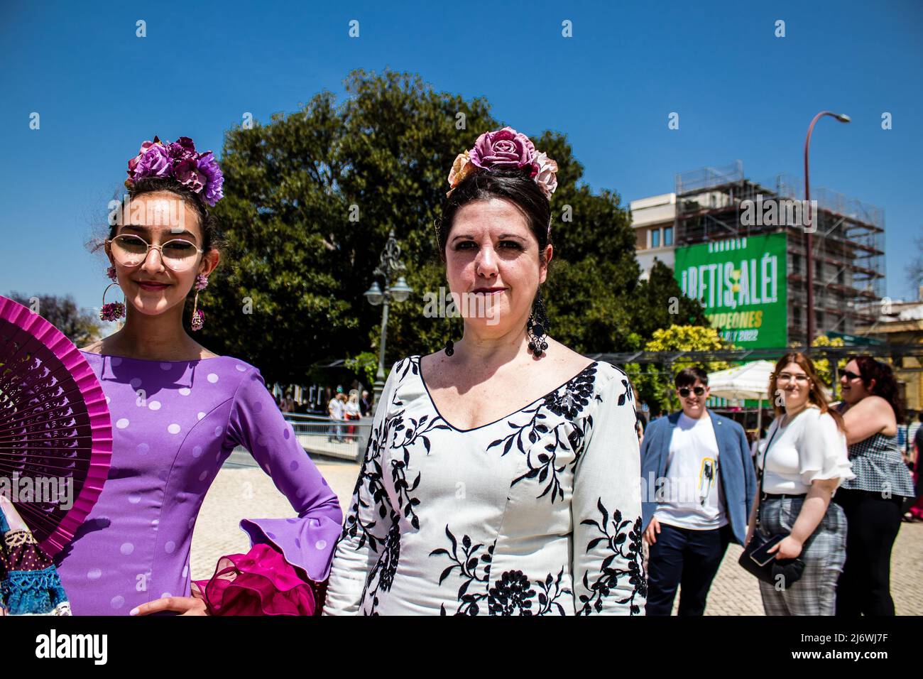Seville, Spain - May 01, 2022 Sevillians dressed in traditional ...