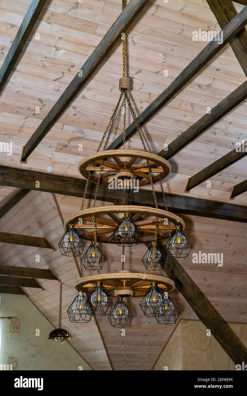 Large modern chandelier in antique style. Wooden building design ...