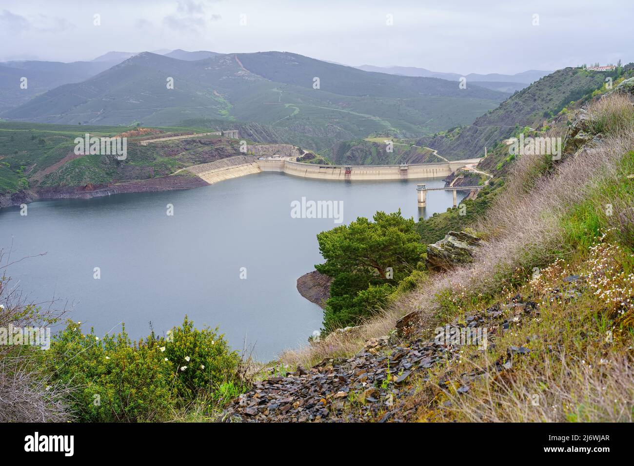 Green landscape with mountains with fog and reservoir with dam at the ...