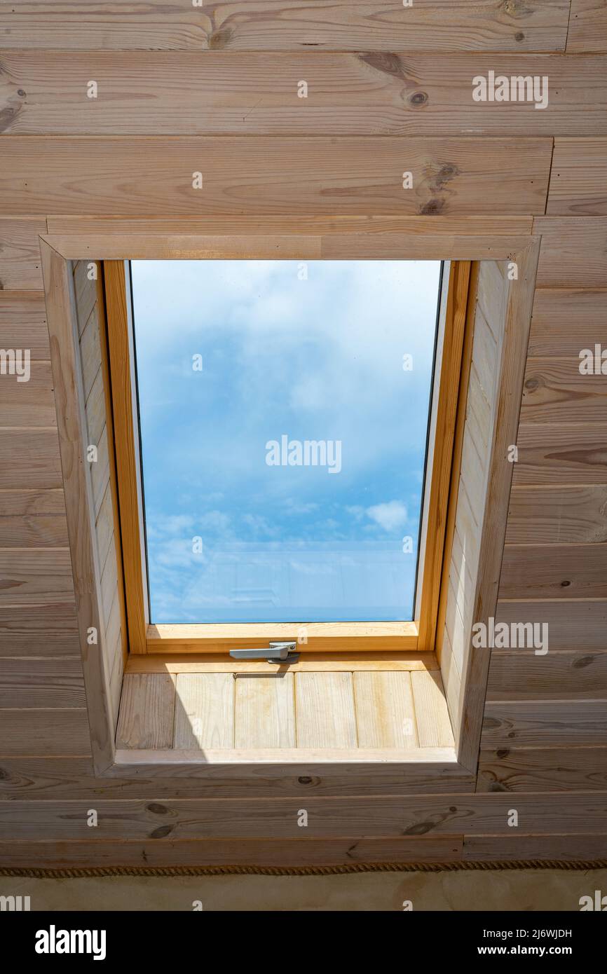 Window in the attic of a wooden house. Window in the middle of the ...