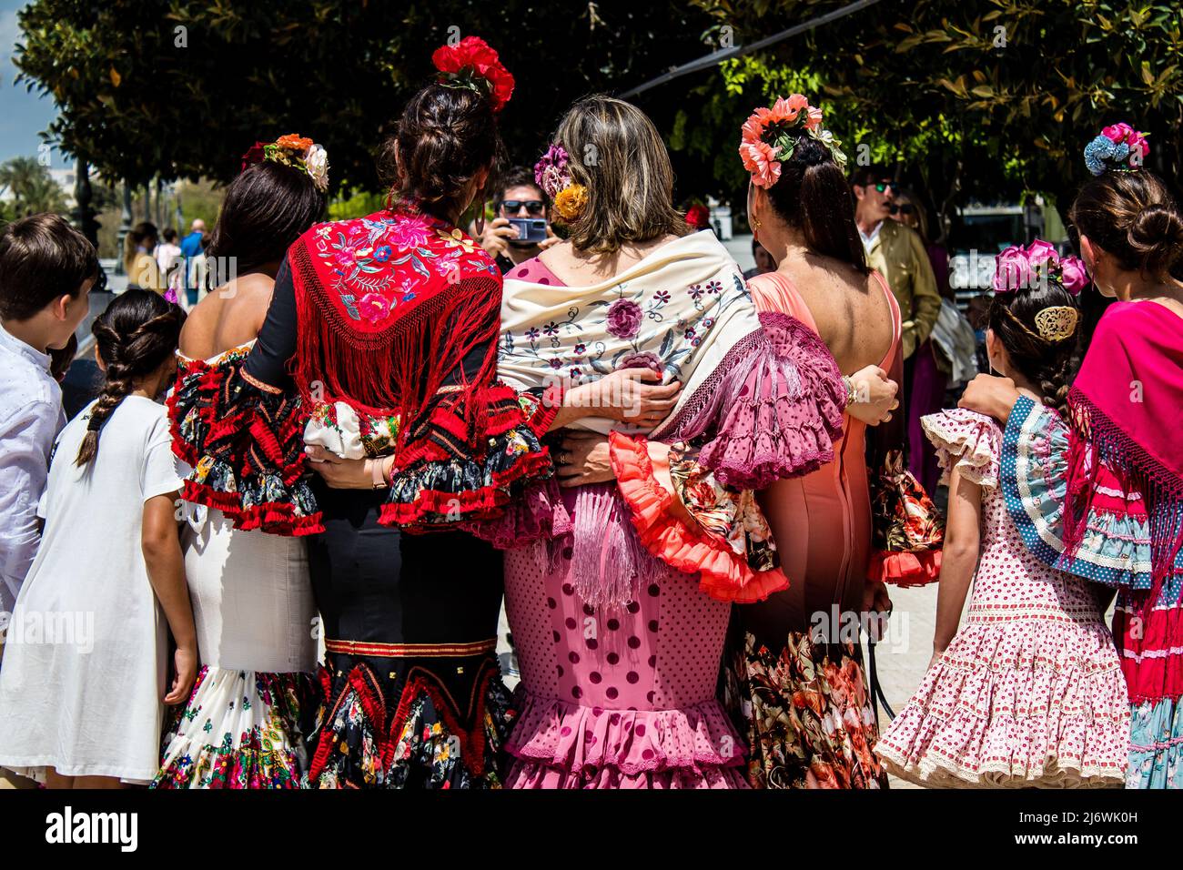 Seville, Spain - May 01, 2022 Sevillians dressed in traditional ...