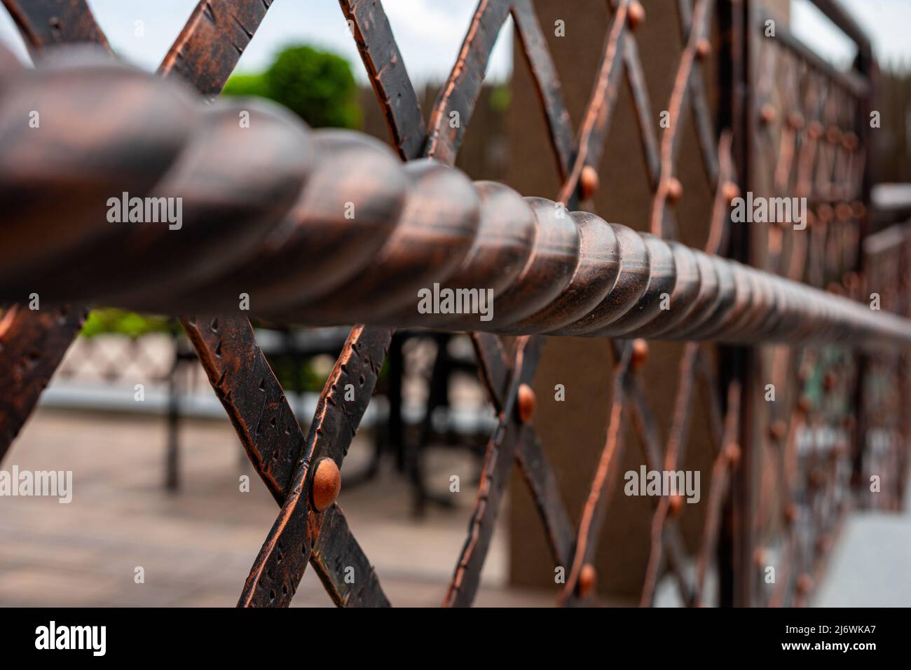 Wrought and twisted iron handrails. Metal products. Stylization of ...