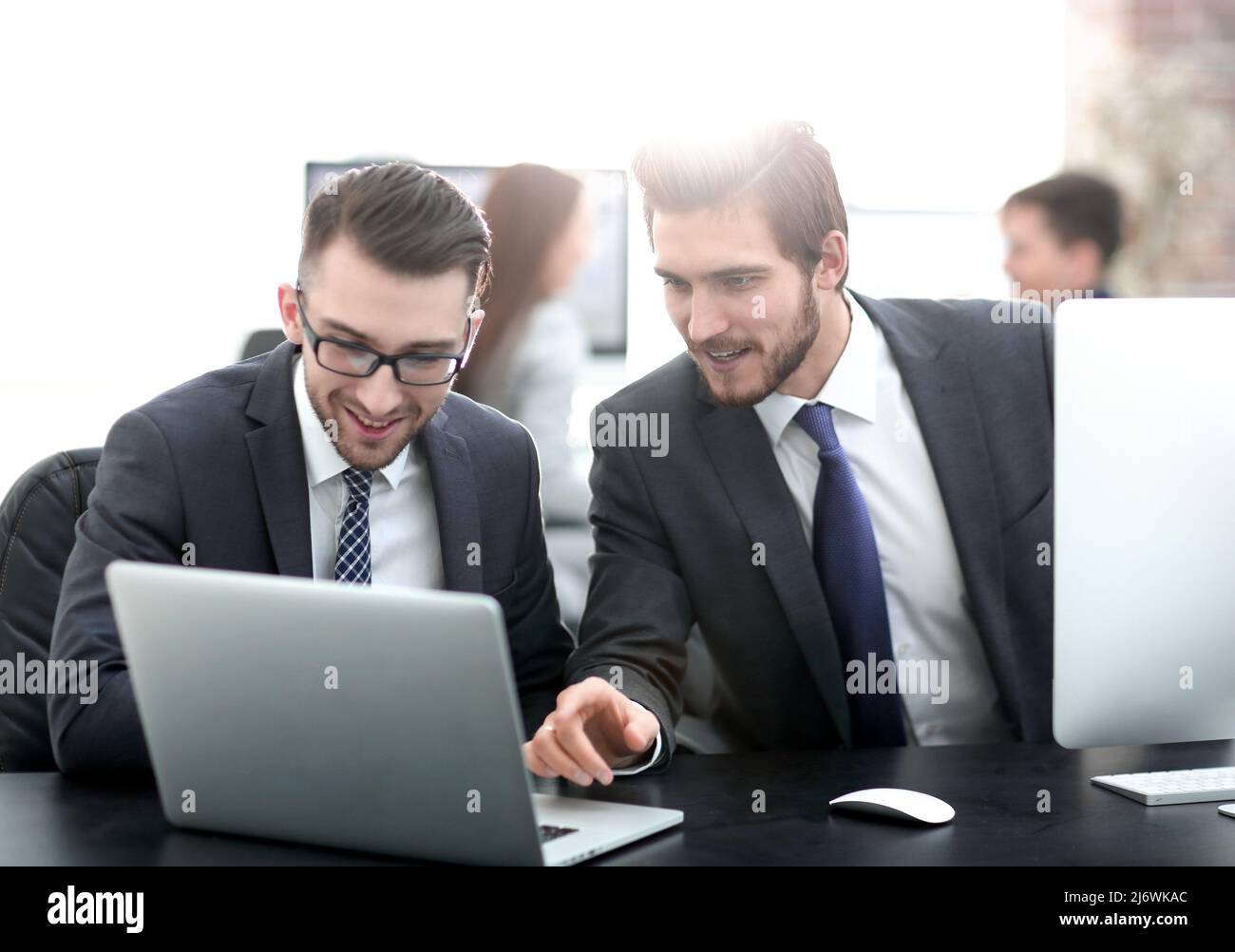 Businessman explaining his offer to business partner Stock Photo - Alamy