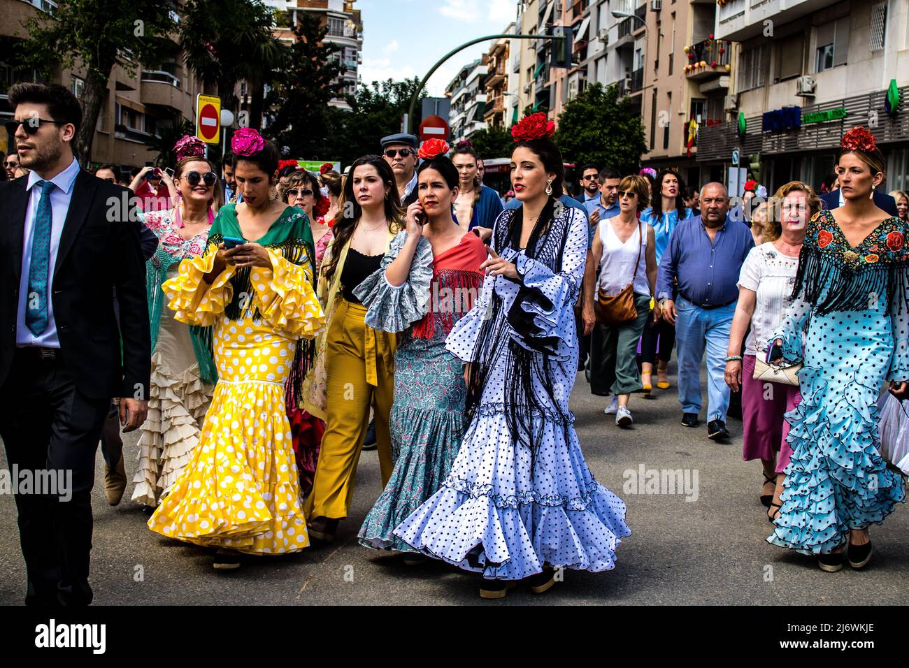 Seville, Spain - May 01, 2022 Sevillians dressed in traditional ...
