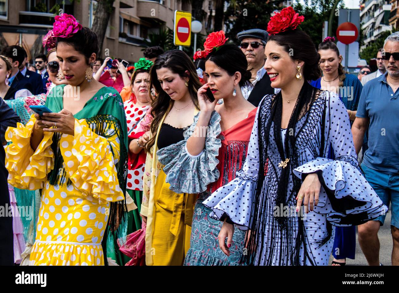 Seville, Spain - May 01, 2022 Sevillians dressed in traditional ...
