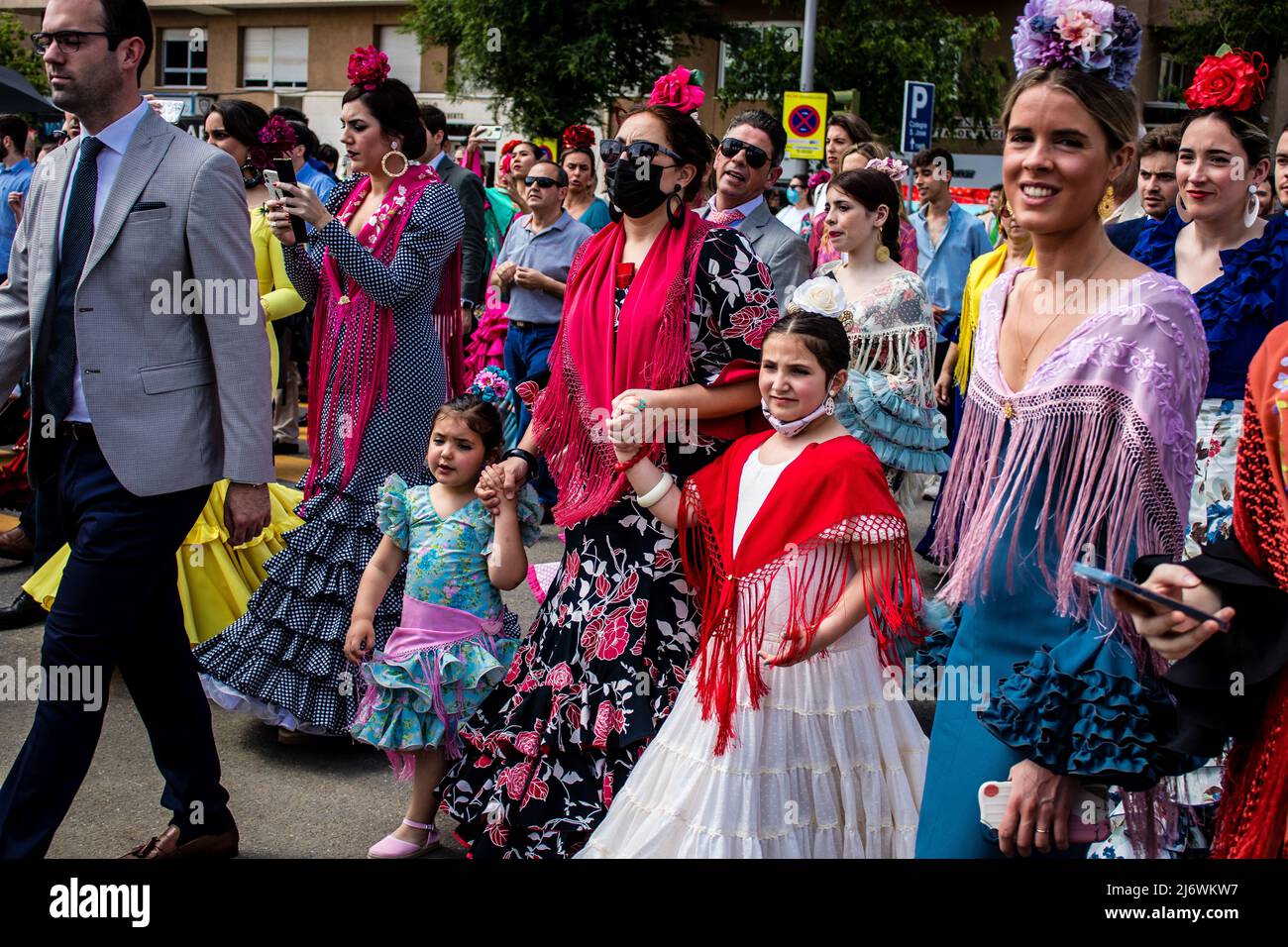 Seville, Spain - May 01, 2022 Sevillians dressed in traditional ...