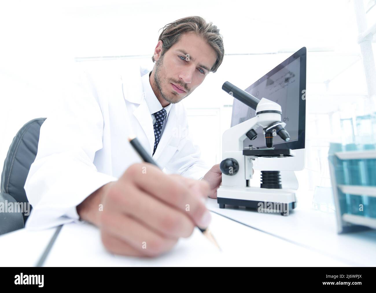 scientist makes a note of experiment in the laboratory Stock Photo - Alamy