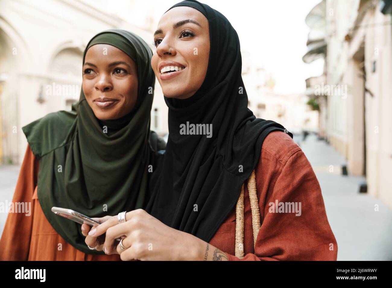 Two young muslim women walking hi-res stock photography and images - Alamy