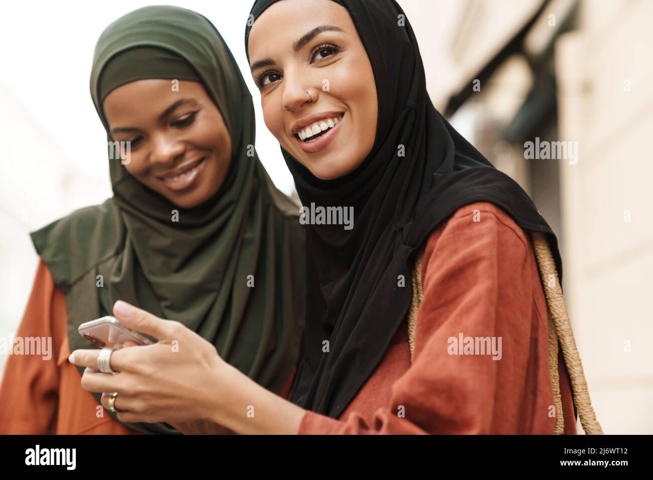 Two young muslim women walking hi-res stock photography and images - Alamy