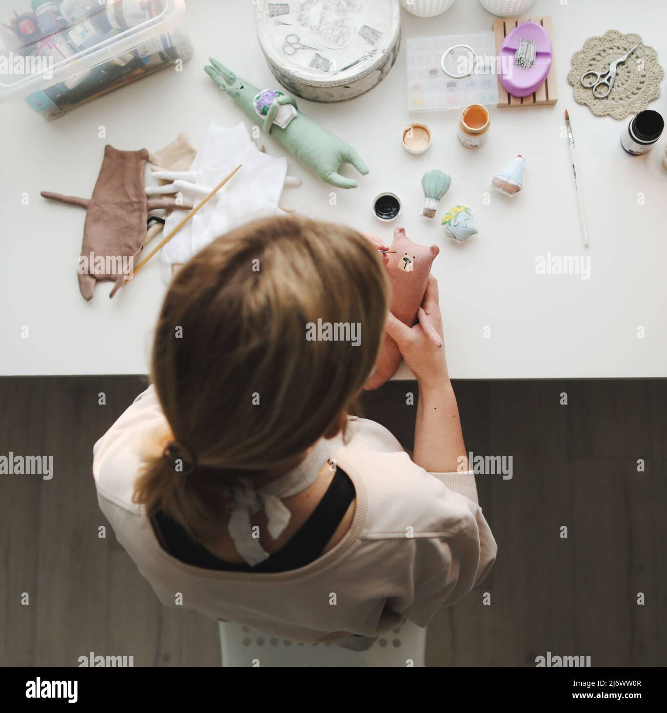 Process of making toy, top view. Woman making handmade teddy toy, home ...