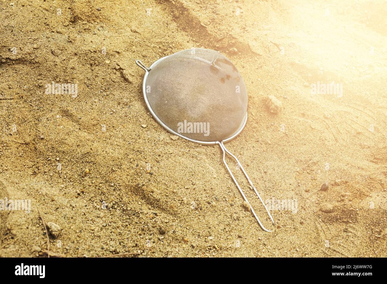 Sieve in the sand.Digging for fossils.Summer season Stock Photo - Alamy