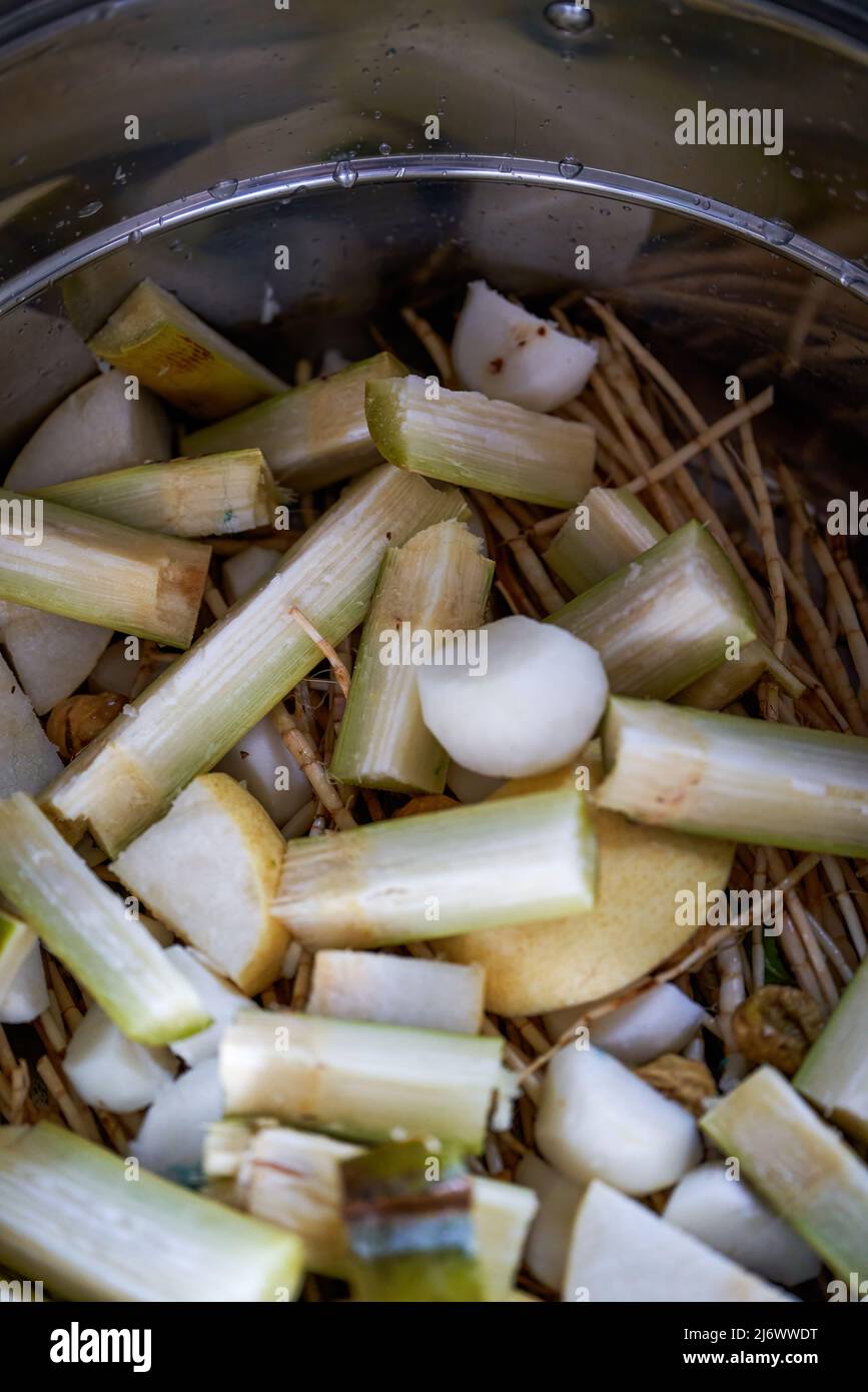 A pot of Cantonese traditional herbal tea, choke root sugar cane water ...