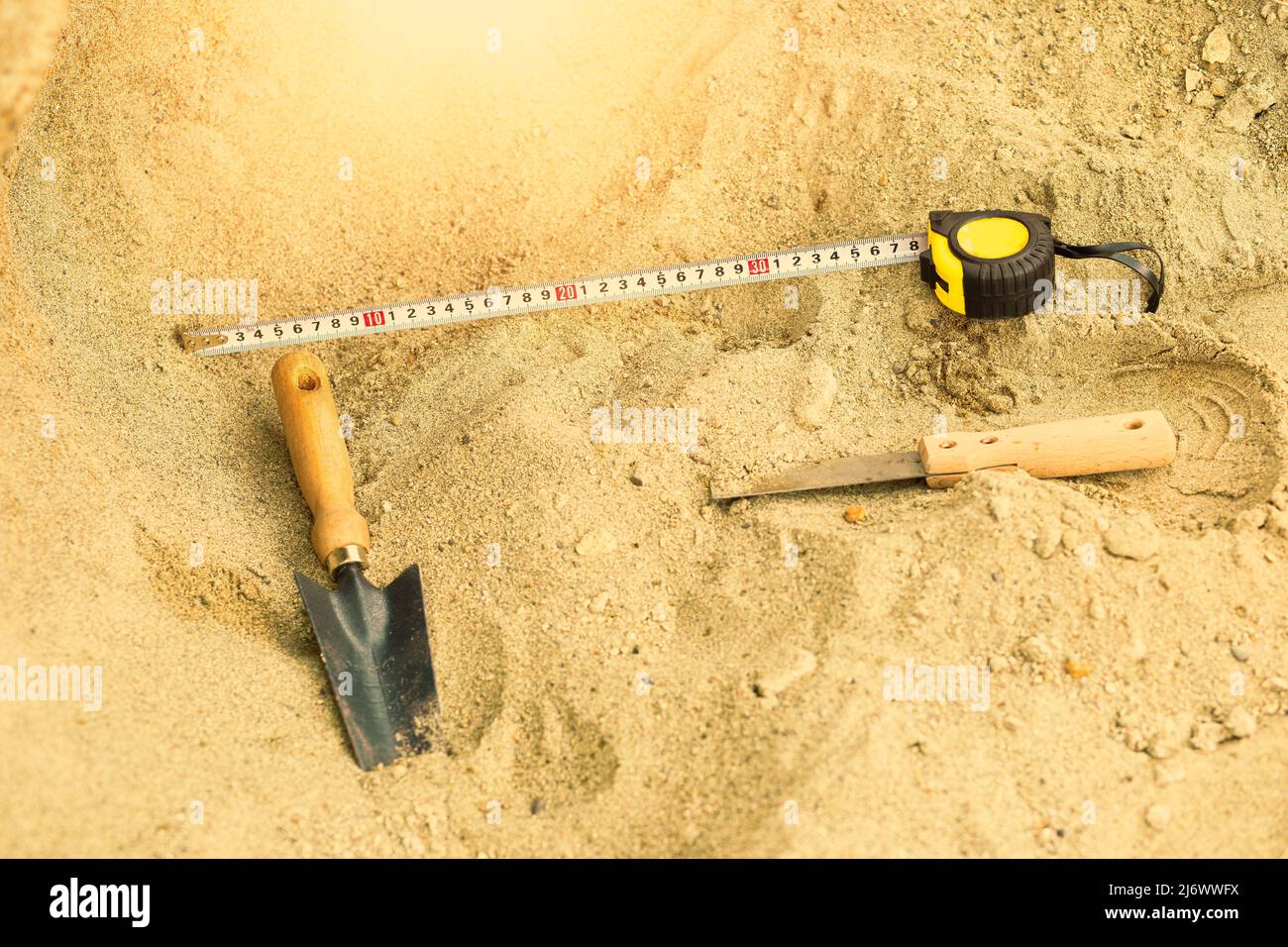Shovel in the sand.Skeleton and archaeological tools.Digging for ...
