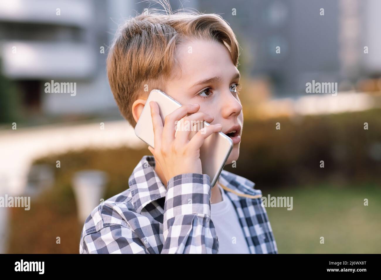 Boy talking on his mobile in school hi-res stock photography and images ...