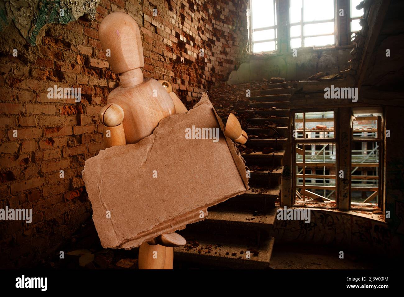 wooden puppet with a poster against the background of a destroyed ...