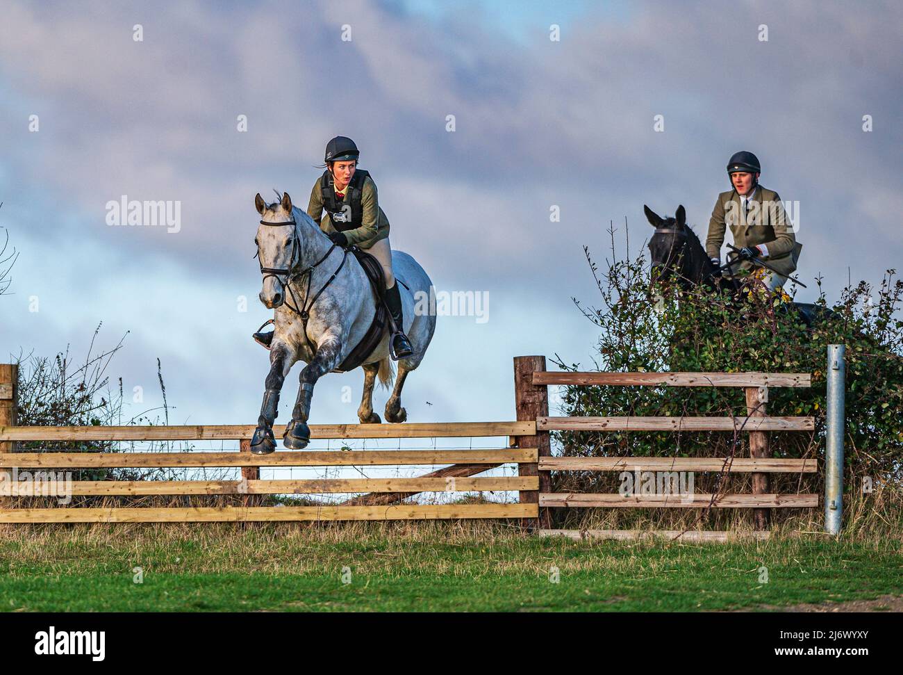 Horse riders jumping and galloping across the skyline on a horse ...