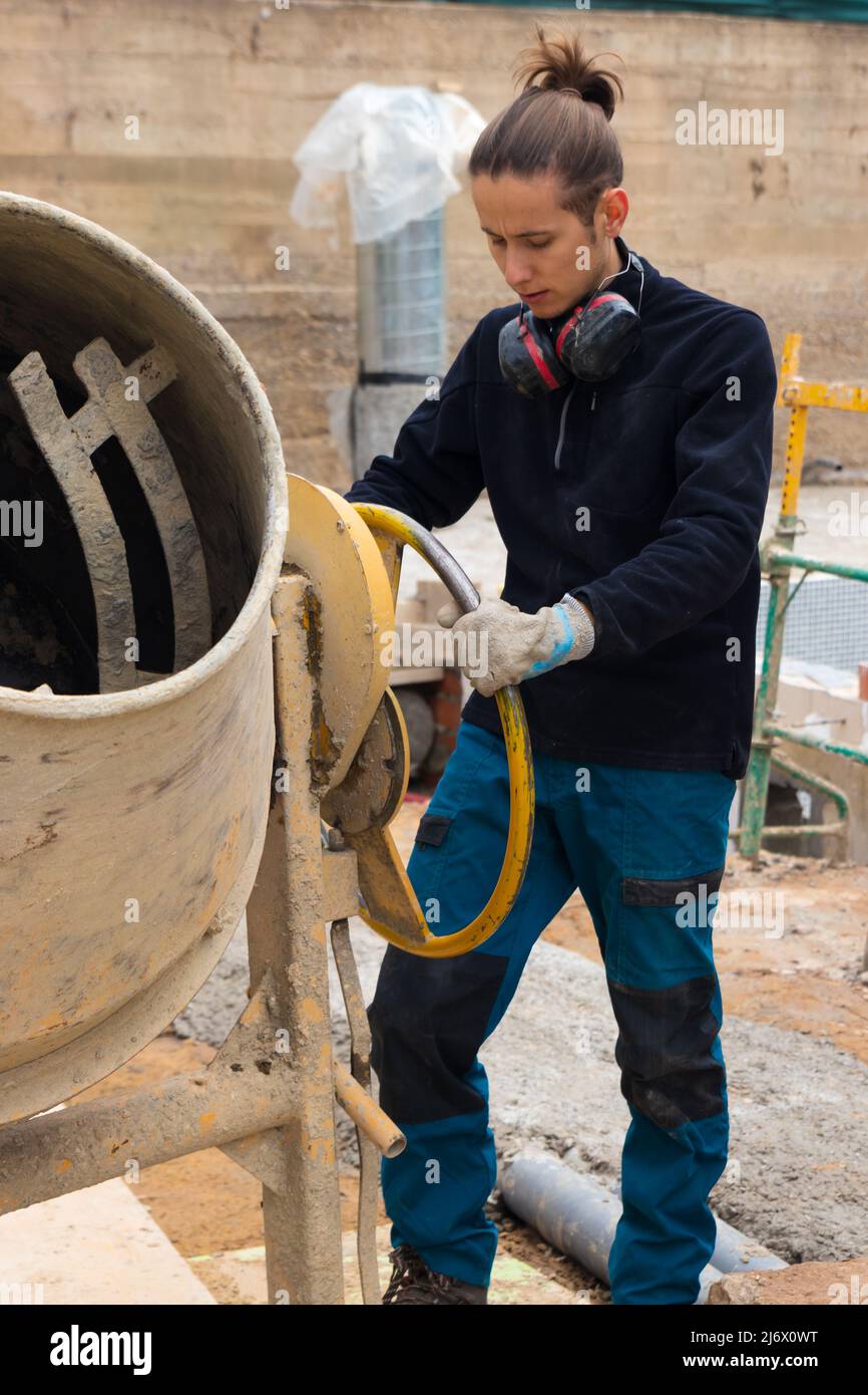 Construction man worker making and preparing concrete in the cement ...