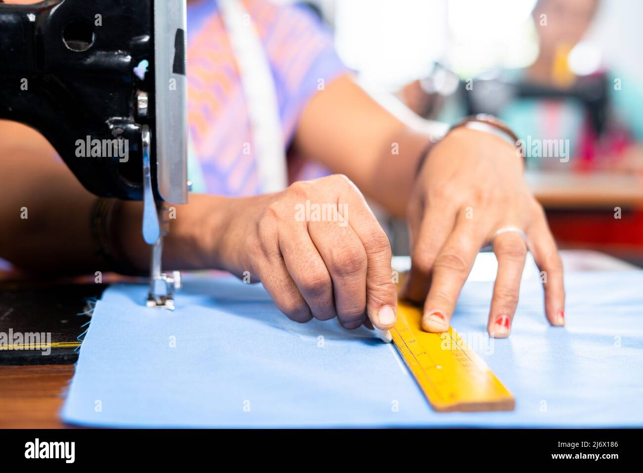 Close up shot of women hands marking measuring cloth with using wood ...