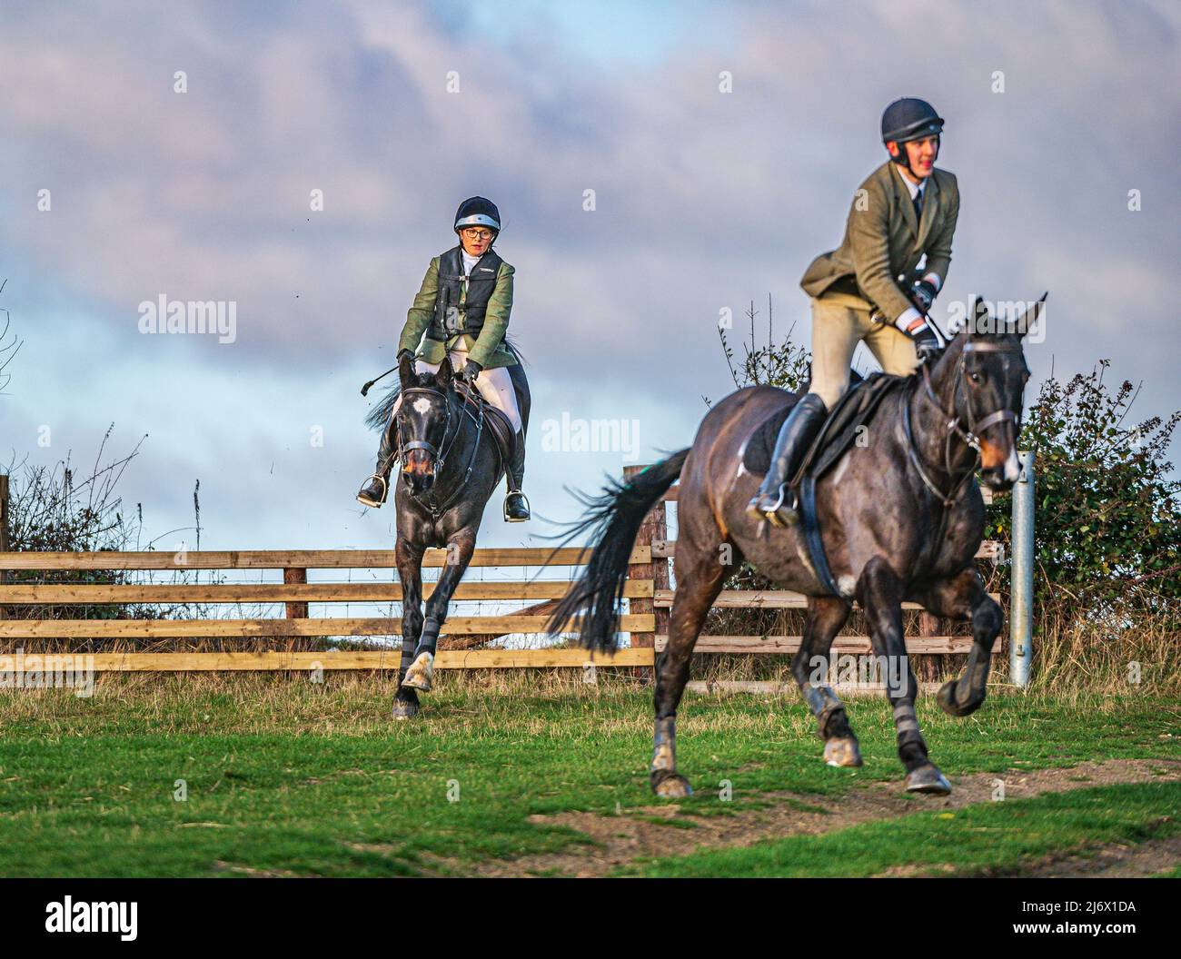 Horse riders jumping and galloping across the skyline on a horse ...