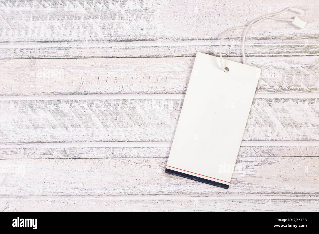 white Blank tag on a light wooden background Stock Photo - Alamy