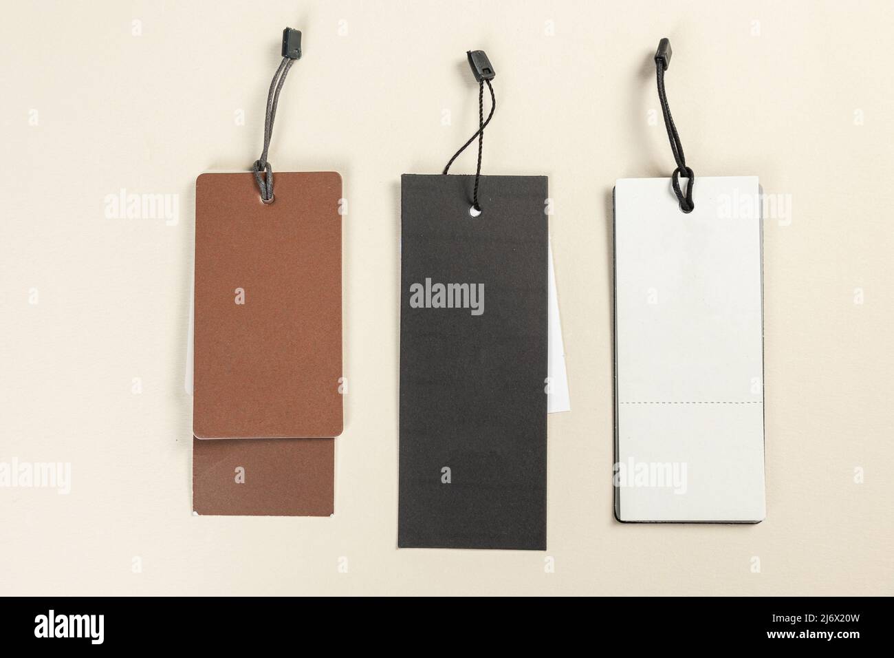 Clothing tag, label blank mockup template on a beige background place ...
