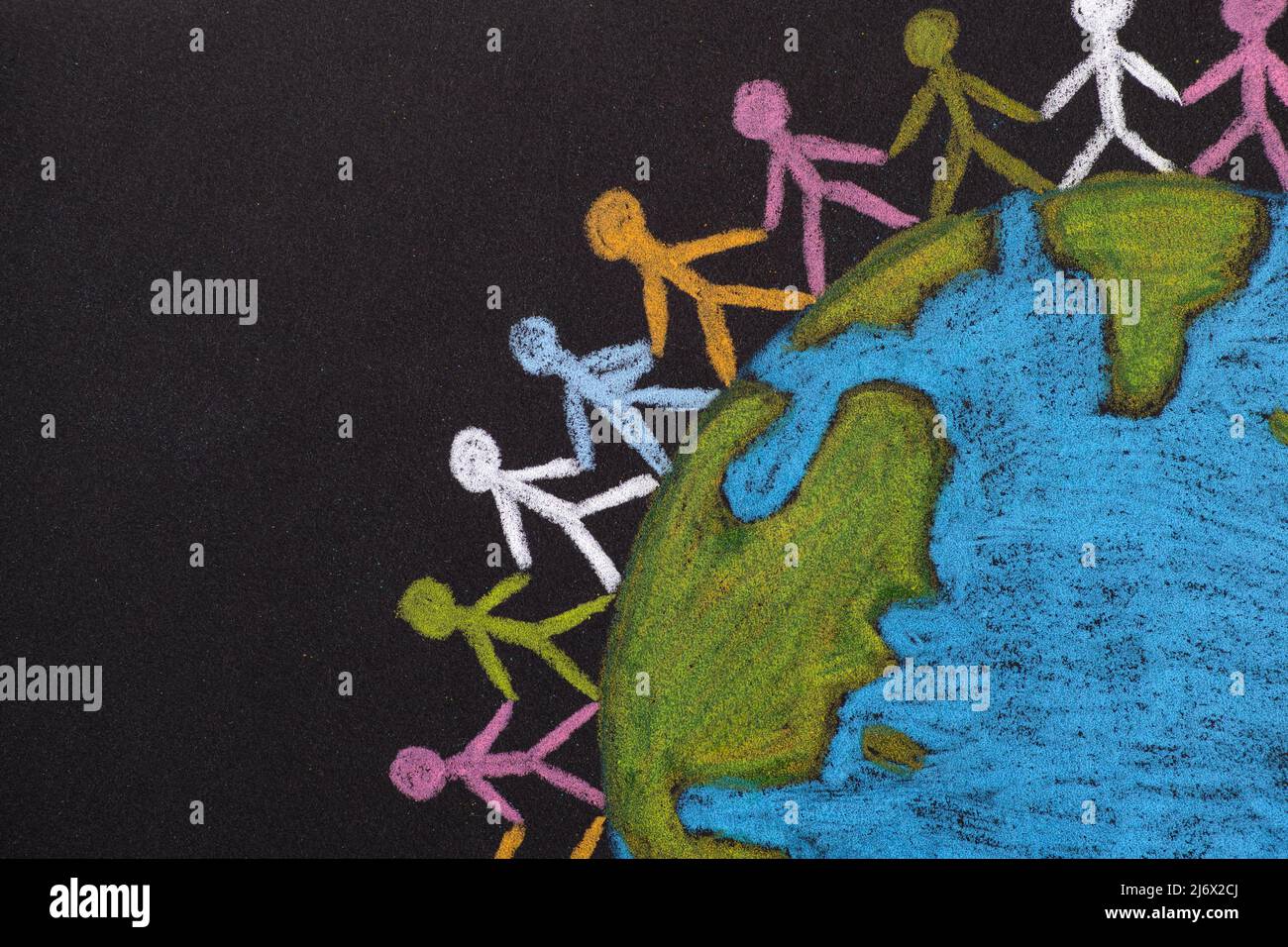 A group of people around the world. Pencil drawing on a black paper ...