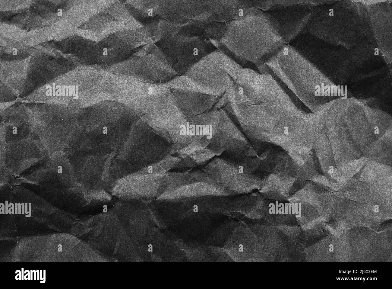 Background from crumpled black paper. Dark paper with folds, scuffs and ...