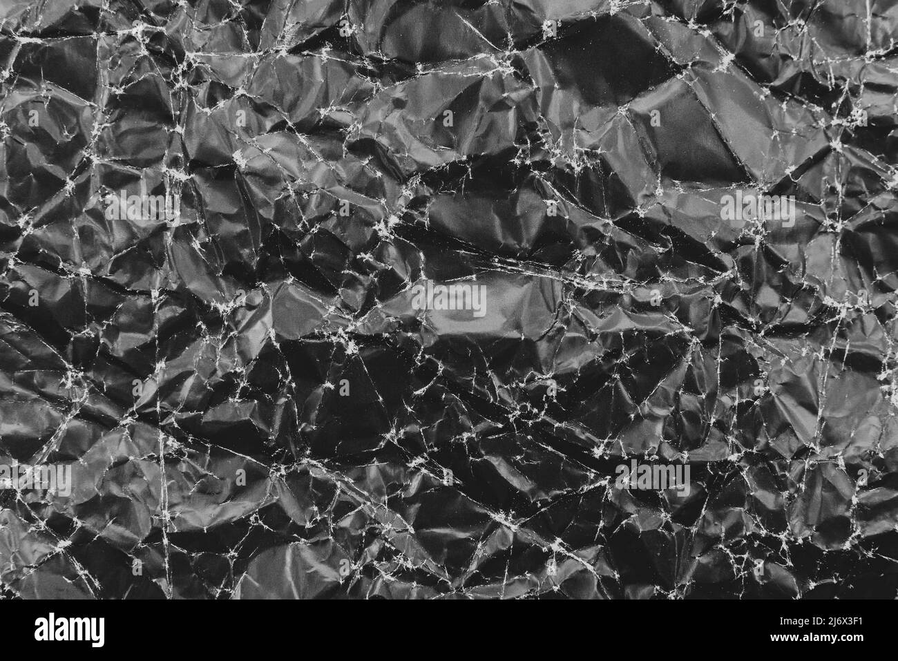 Background from crumpled black paper. Dark paper with folds, scuffs and ...