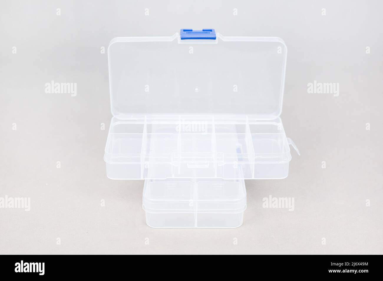 Plastic transparent boxes with individual cells with blue lid on a ...