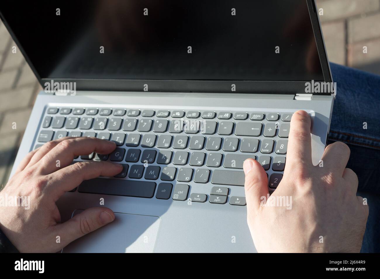 Male hands laptop keyboard typing text, the concept of a freelancer's ...