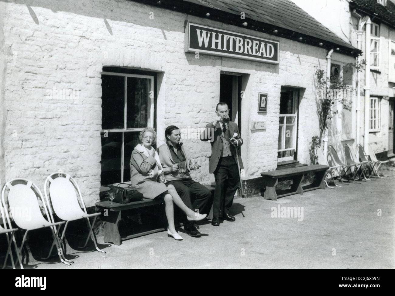 People drink outside a Whitbread pub on the Isle of Wight, England in ...