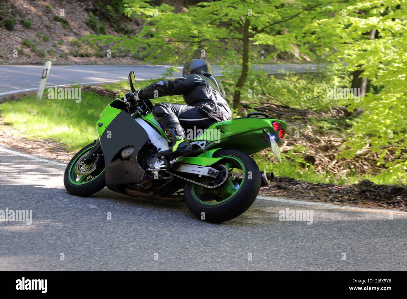 Sporty motorcyclist photographed from behind Stock Photo - Alamy