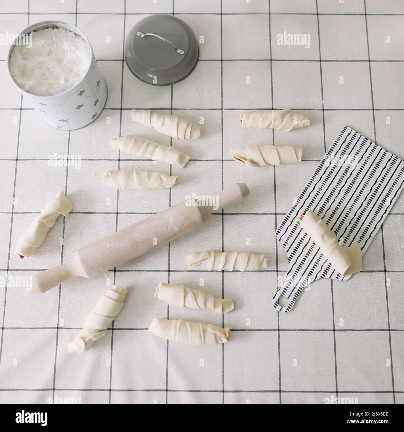 homemade baking. wooden rolling pin with dough on the kitchen table ...