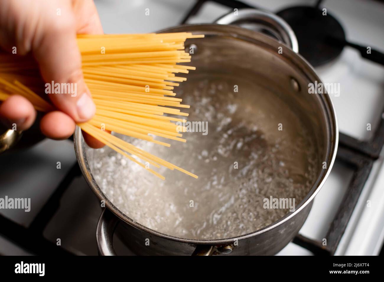 Pasta cooking hand pot kitchen hi-res stock photography and images - Alamy