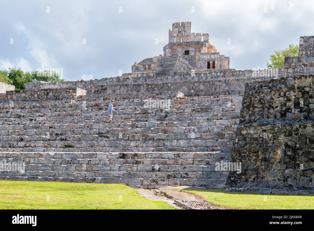 Woman ascending a great central staircase on the Edzna archaeological ...