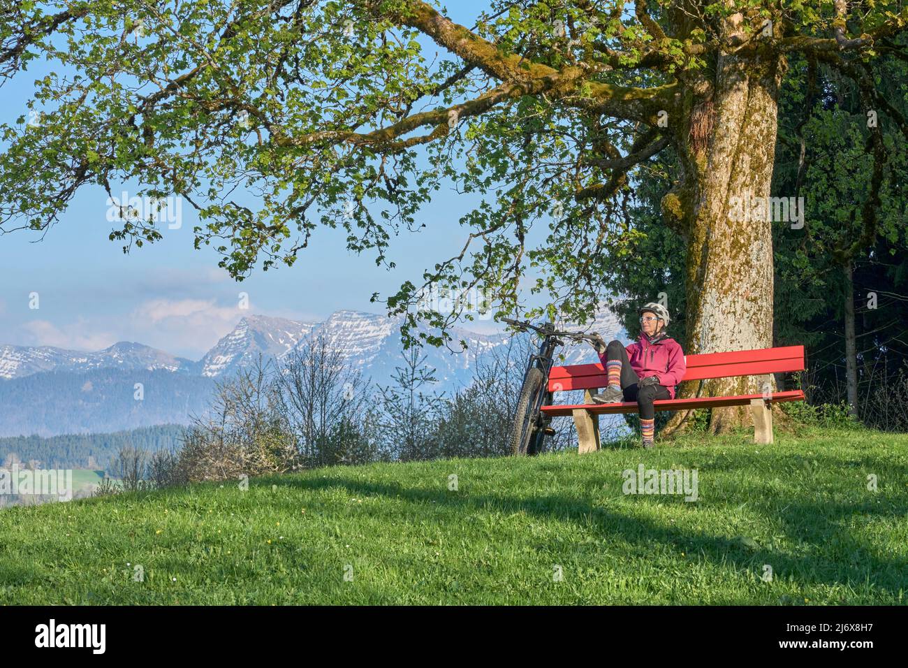 pretty senior woman having a break during a mountain bike tour in ...