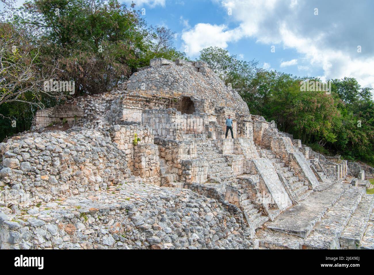 Tourist posing in front of the ruins of north temple in ancient mayan ...