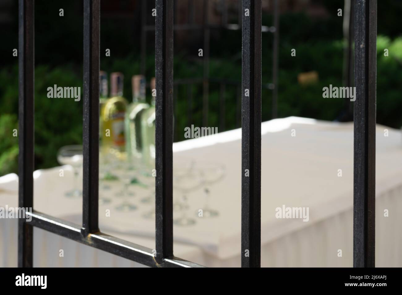 Prohibition of alcohol. Bottles of alcohol behind bars Stock Photo - Alamy