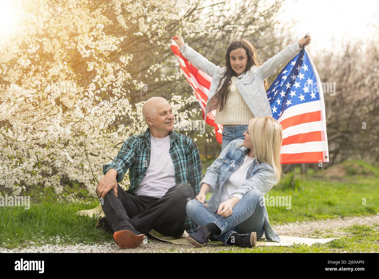 american family with USA flag outdoors Stock Photo - Alamy