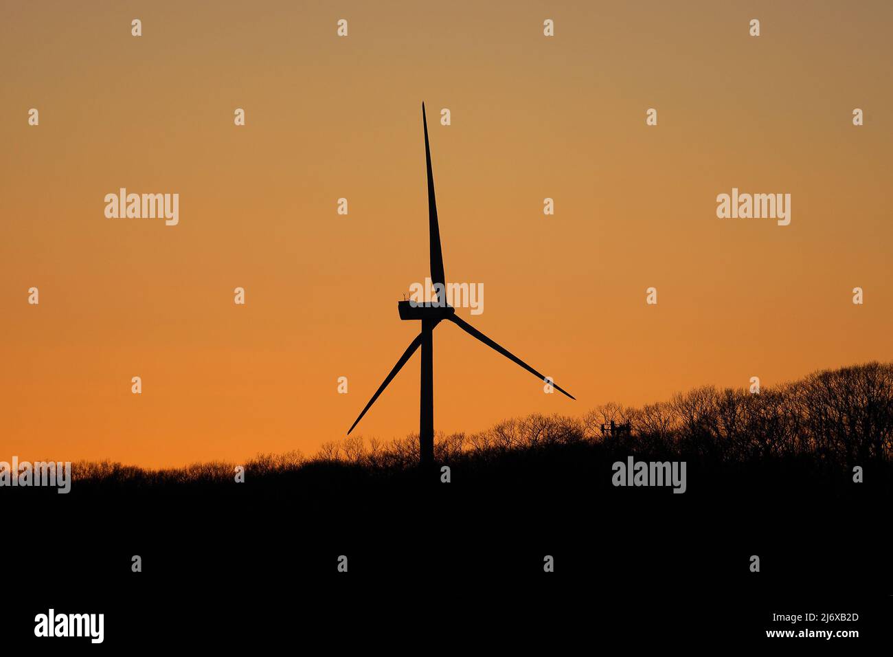Wind turbine with sunset sky background Stock Photo - Alamy