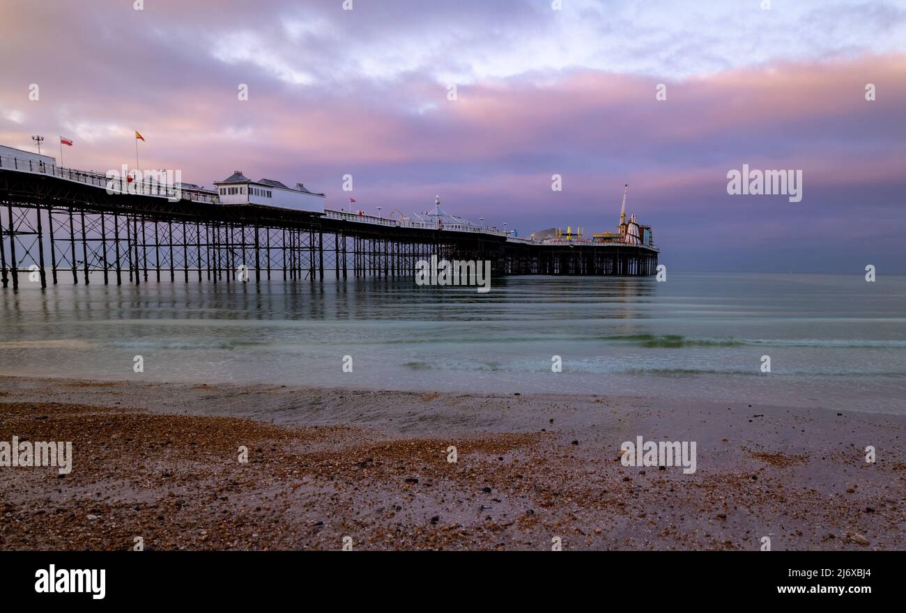 Stunning low angle shot of Brighton Pier during the morning twilight ...