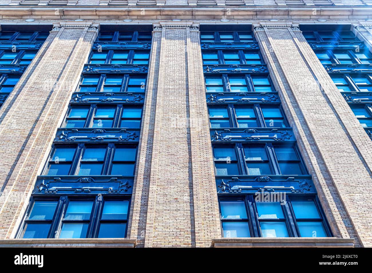 Low angle view of a set of windows. The colonial style architecture is ...