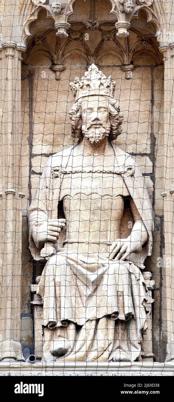 Statue of a seated english king (with crown and beard) above the west ...