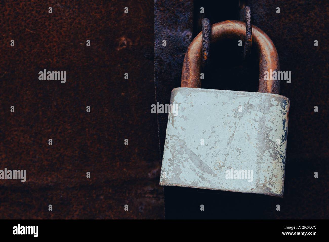 Old padlock. Door lock in the form of a heart. Closed door. The ...