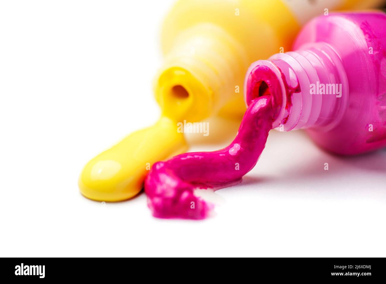 Close-up of two open tubes with magenta and yellow artists' paint ...