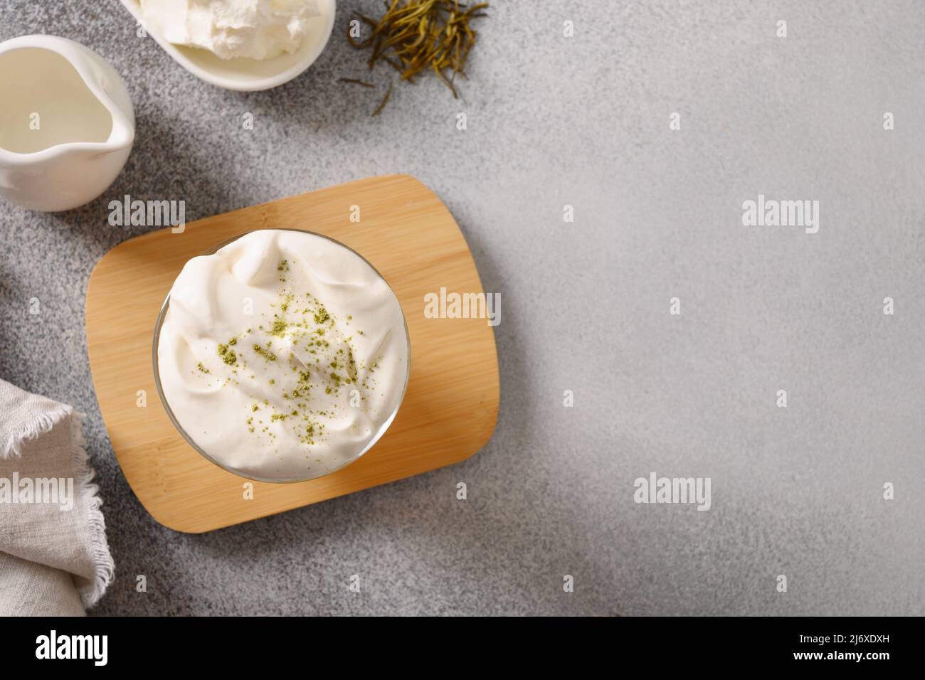 Cheese Tea with creamy foam topped matcha powder on gray background ...