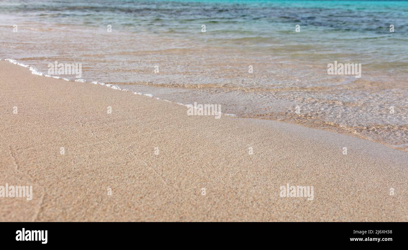 Empty sandy beach in Greece, close up view. Sea water touch wet white ...