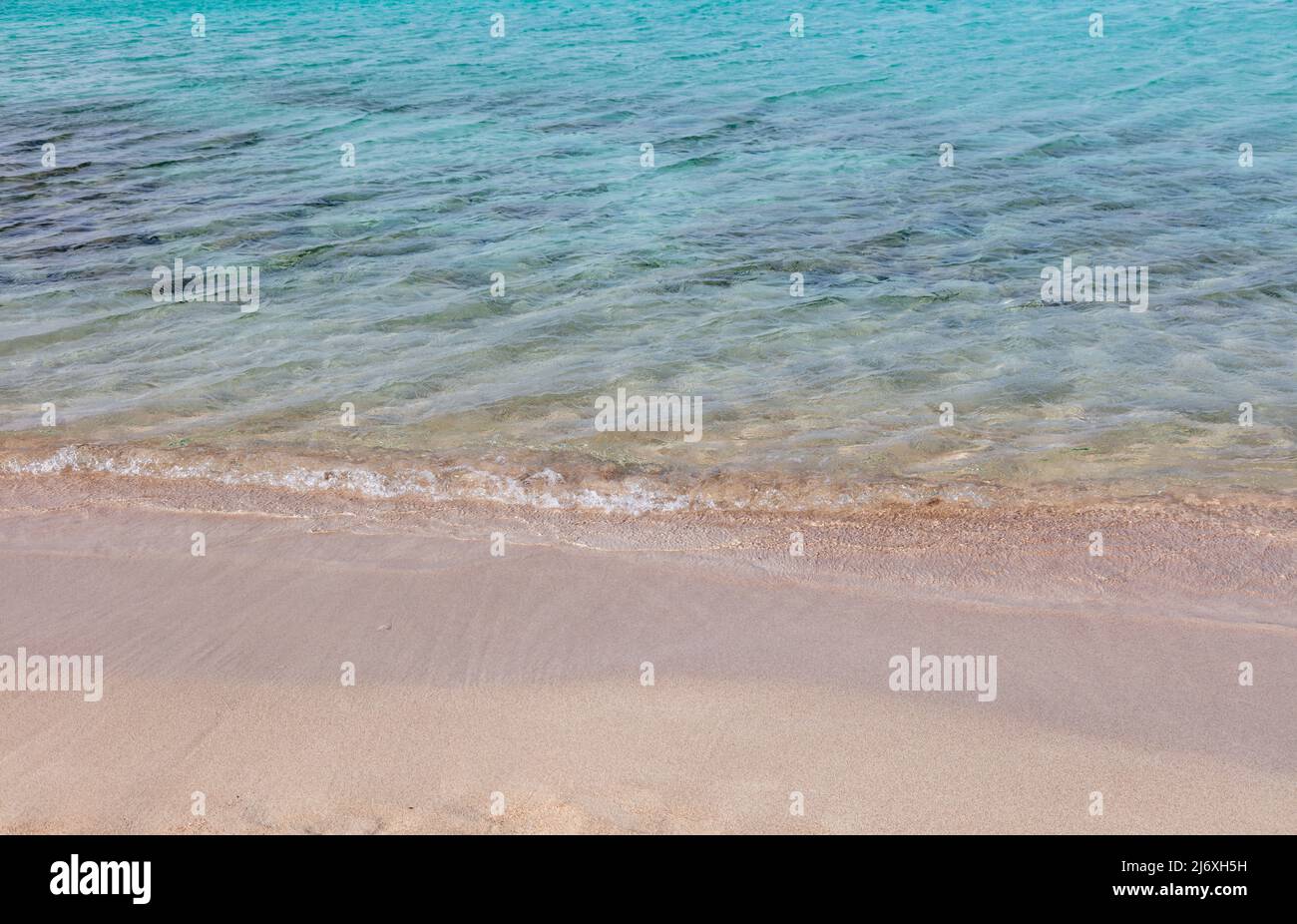 Empty sandy beach in Greece, close up view. Sea water touch wet white ...